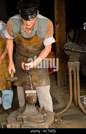 A blacksmith hammering hot iron Stock Photo - Alamy