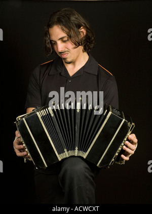 Bandoneon, tango instrument, front view oin pink paper background with ...