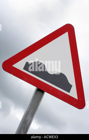 Warning sign with red triangle to indicate danger of falling rocks in a ...