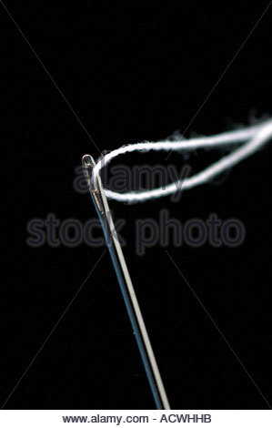 Eyelet of needle close up. sewing needles is inserted into the foam ...