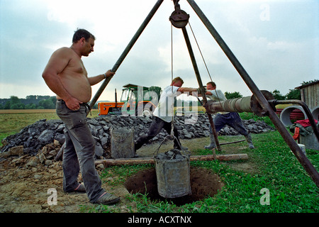 Men digging a well, Poland Stock Photo - Alamy
