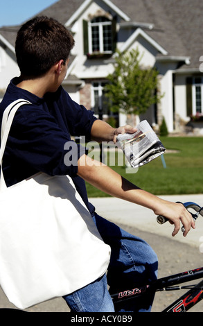 Boy delivering newspaper Stock Photo - Alamy