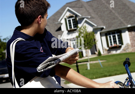 Boy delivering newspaper Stock Photo - Alamy