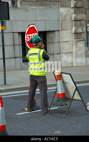 Workman holding GO sign Stock Photo - Alamy