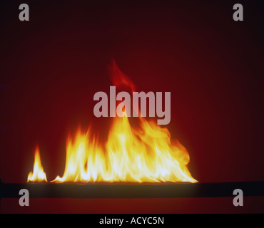 Flames in the fire of a red and yellow barbecue Stock Photo - Alamy