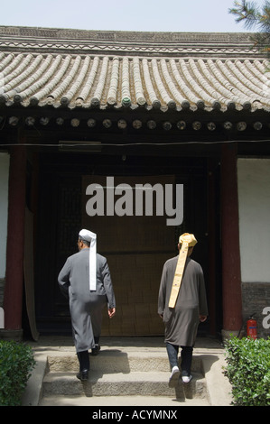 two chinese hui men pray at Xining's Great Mosque in their daily ...