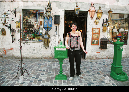 Waitress having cigarette break in front of shutters and beer barrels ...