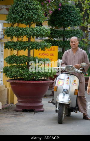 Asia Vietnam Buddhist monk smoking cigarette at small temple along Yen ...