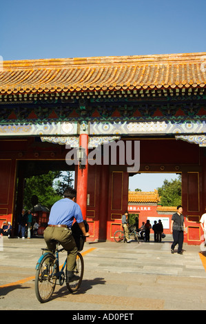 A cyclist at a gate to Zijin Cheng The Forbidden City Palace Museum ...