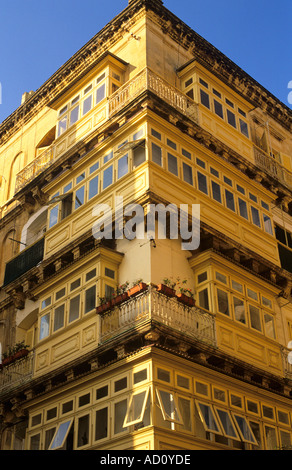 Traditional house detail in Malta. Limestone yellow bricks and colorful ...