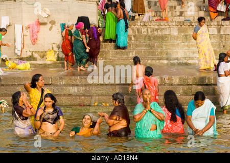 Indian people perform their daily bathing and prayer rituals at the ...