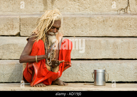Male pilgrim with a long beard and moustache praying at the Ganga Sagar ...