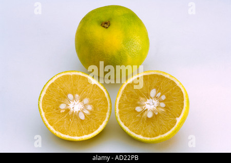 Fruits, One full uncut Sweet Lime and one cut two half green yellow ...