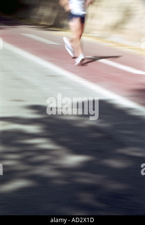 one jogger running along cycle path blurred Stock Photo - Alamy