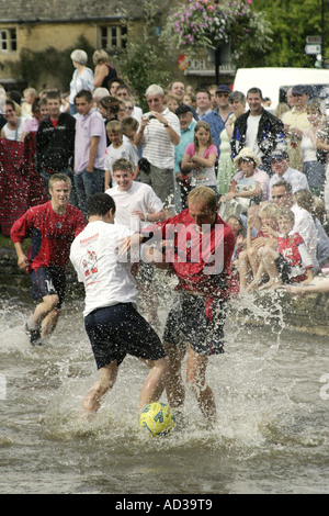 Football in the river Windrush, Bourton on the Water, Gloucestershire ...