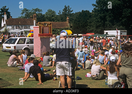 TILFORD VILLAGE SUMMER FETE with children country dancing on a village ...