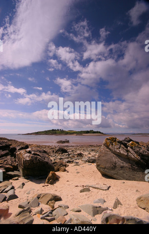 View along the Galloway coastline strewn with rocks boulders and fine ...