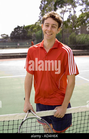 The player is standing behind the tennis net Stock Photo - Alamy