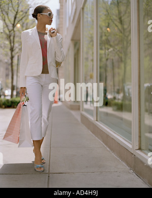 women with shopping bags looking at shop window Stock Photo - Alamy