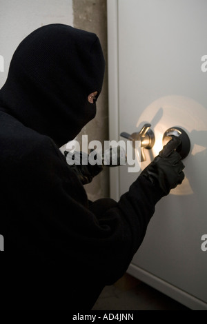 Thief unlocking a combination lock Stock Photo - Alamy