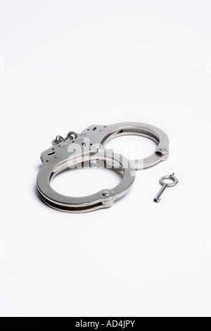 Vertical high angle shot of handcuffs, a syringe, and some dollar bills ...