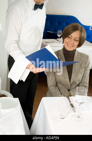 waiter setting up table for customer Stock Photo - Alamy