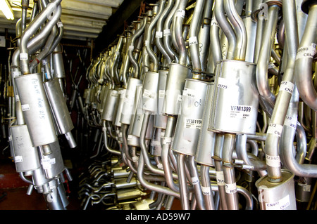Car exhaust systems hanging in warehouse of motor spares shop Stock ...