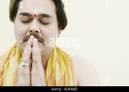 Close-up of a priest praying with his eyes closed Stock Photo - Alamy