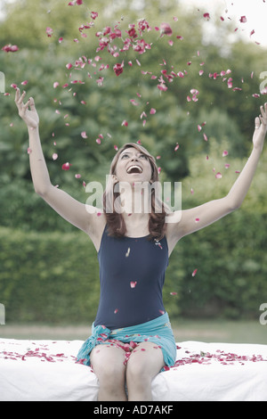 Rose petals falling on a woman Stock Photo - Alamy