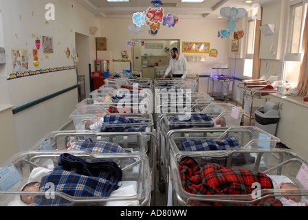 A Haredi Jew stands amid newborn babies at the maternity ward of Bikur ...