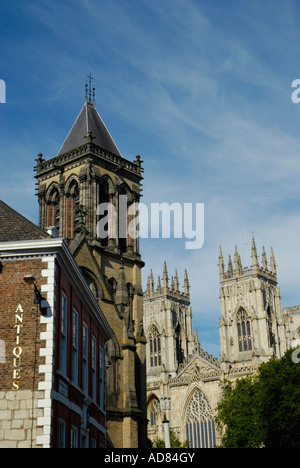 The towers of York Minster and St Wilfrid’s Church from a busy street ...