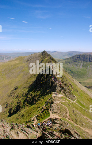 walkers on Striding Edge path with Helvellyn summit behind Stock Photo ...