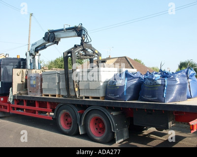 Mechanical unloading Jewson lorry truck of load of insulation blocks ...