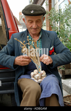 Tying bunch of garlic, France Stock Photo - Alamy