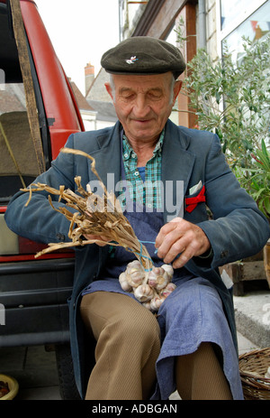 Tying bunch of garlic, France Stock Photo - Alamy