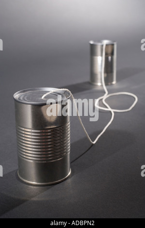 Two cans with string form a simple child's communication device A ...