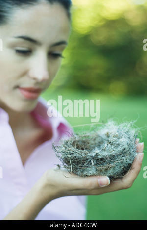 An adult Hispanic woman is holding a nest full of prepared ice creams ...