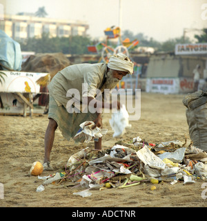 A man sifting through rubbish in the filthy river Bagmati in Kathmandu ...