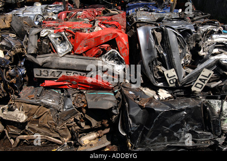 Crushed cars squashed into a huge pile at a car recycling and salvage ...