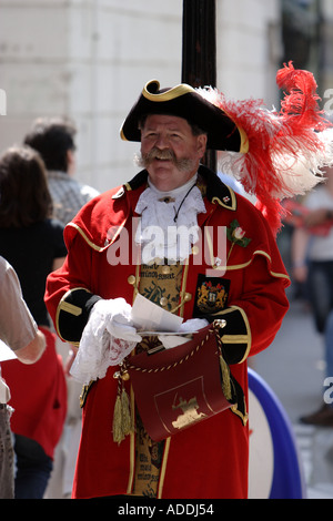 Male town crier (colourful red braided crier's livery) proclaiming ...