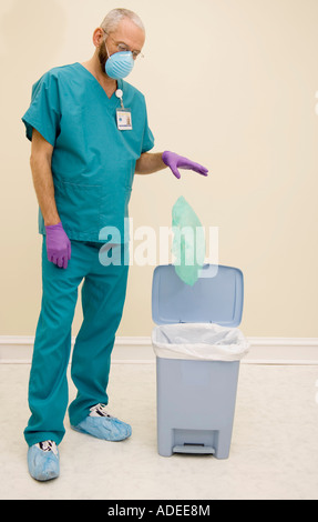 Nurse throws medical garbage into Medical waste bin in office. A female ...