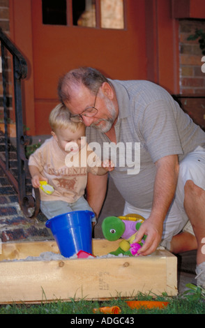 Grandfather and grandson playing in sandbox Minneapolis Minnesota Stock ...