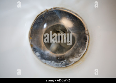 Water disappearing down the plug hole in a sink Stock Photo - Alamy