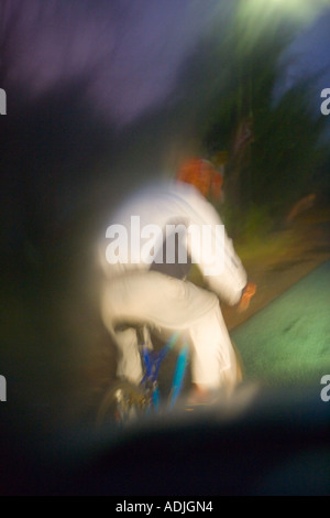 Hazardous roads at night in Mauritius. A cyclist caught in car's ...