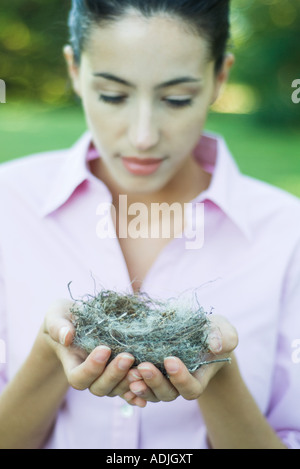 An adult Hispanic woman is holding a nest full of prepared ice creams ...