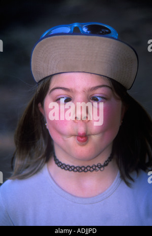 child making a cross eyed face while playing with nose Stock Photo - Alamy