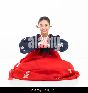 A Korean woman wearing Hanboek is bowing politely Stock Photo - Alamy