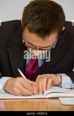 Man in office writing on adhesive notes on wall Stock Photo - Alamy
