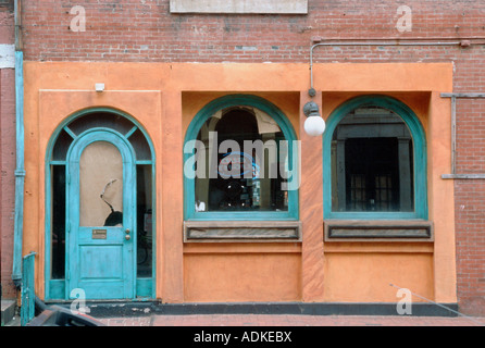 Arched door with broken windows in an old dilapidated Italian building ...