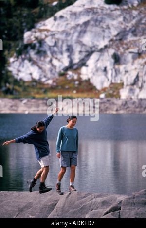 Couple Playing on Rock Together Stock Photo - Alamy